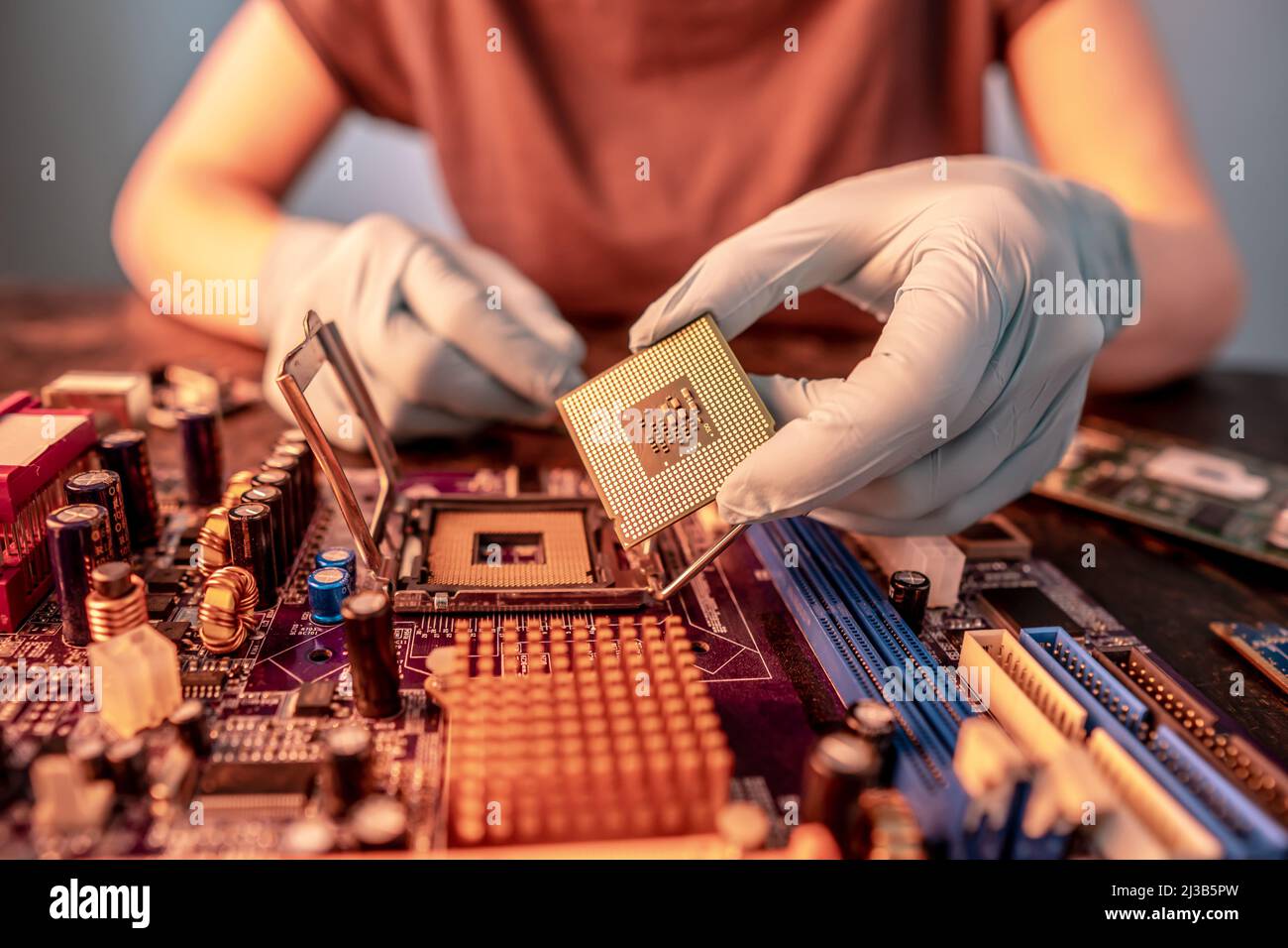 Engineer repairman holding hands in black gloves chip processor, CPU to ...