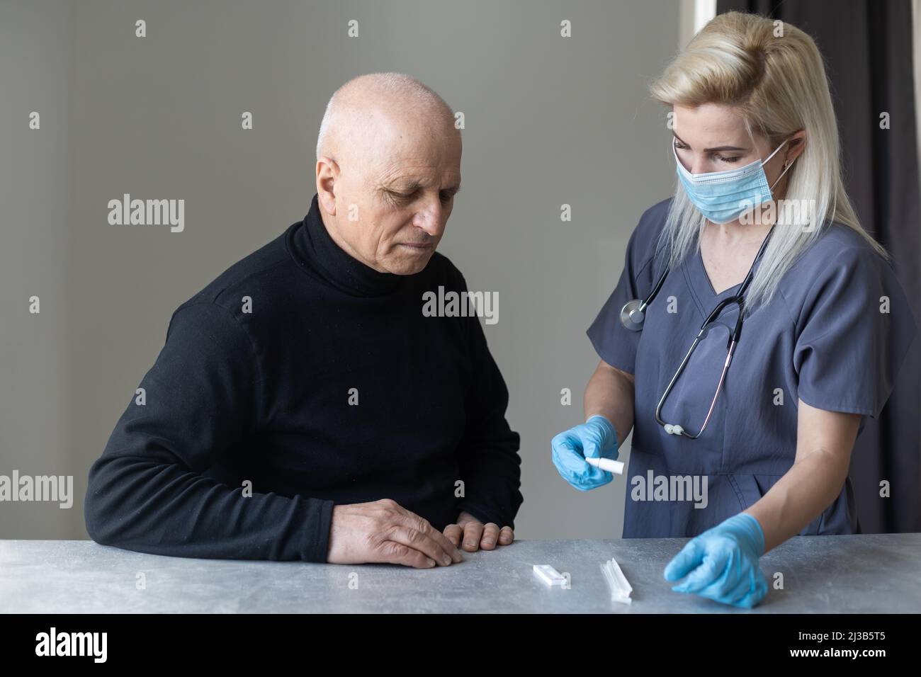 Nurse drawing blood from an elderly man in his home. Home care Stock ...