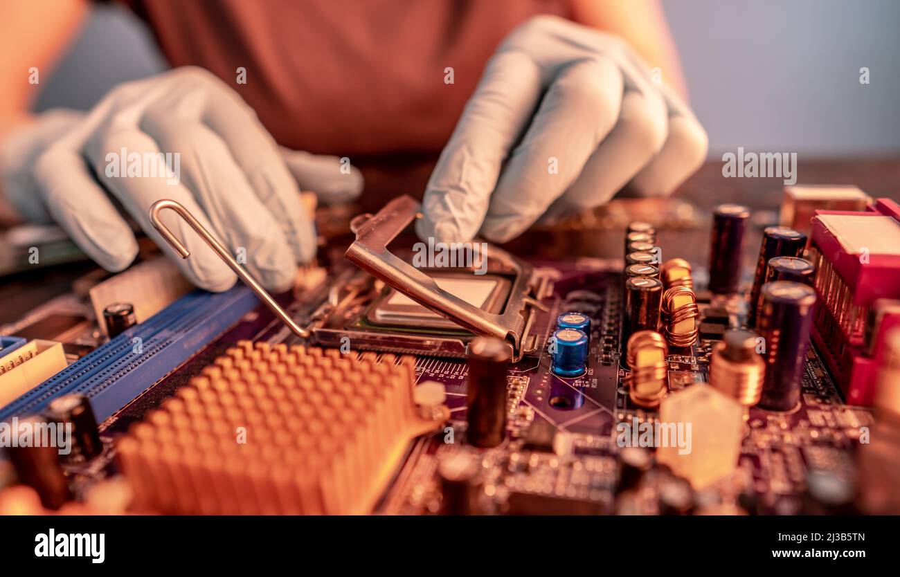 Engineer repairman holding hands in black gloves chip processor, CPU to ...