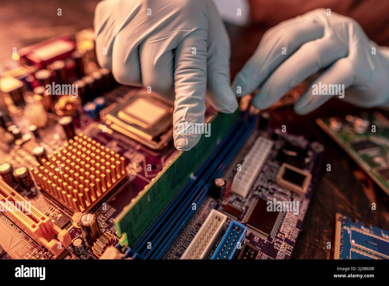 The engineer's gloved hand holds the computer's RAM chip against the ...