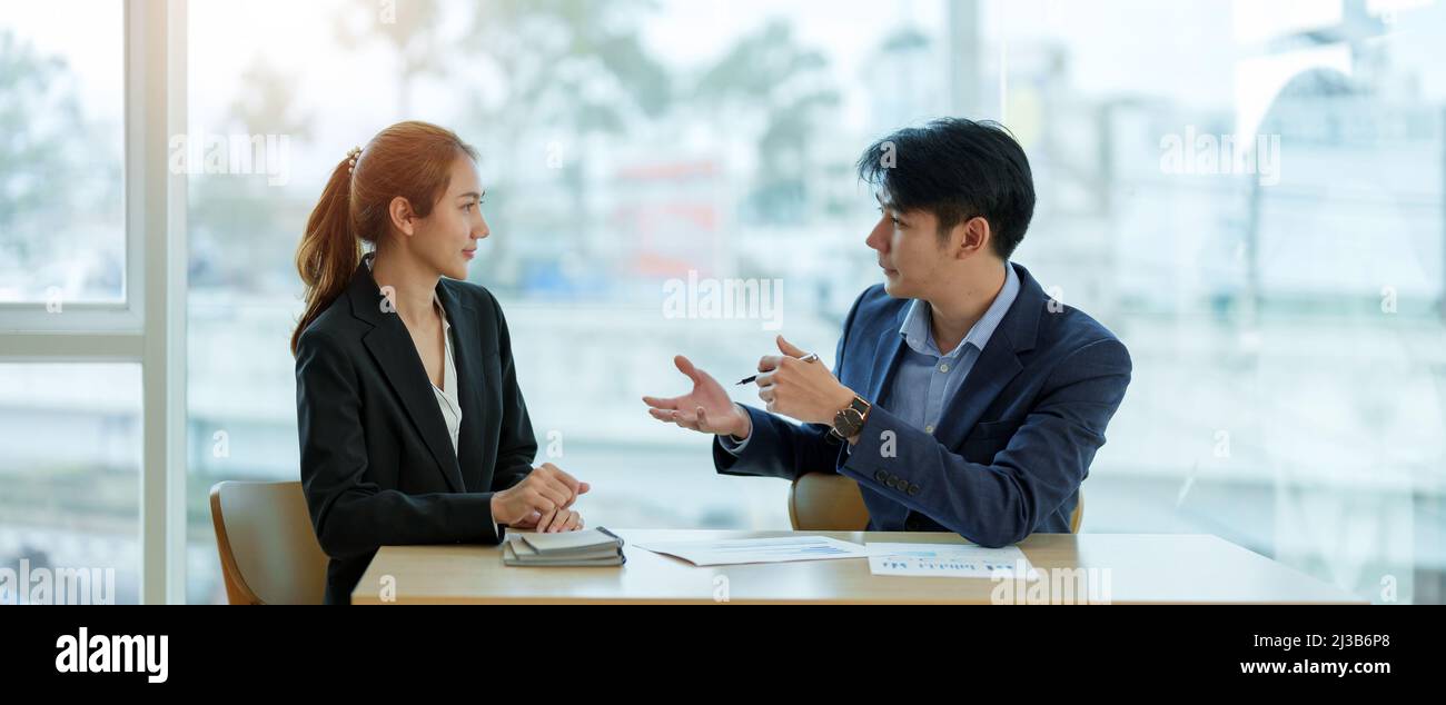 Young asian business partner working and discussing about their neew ...