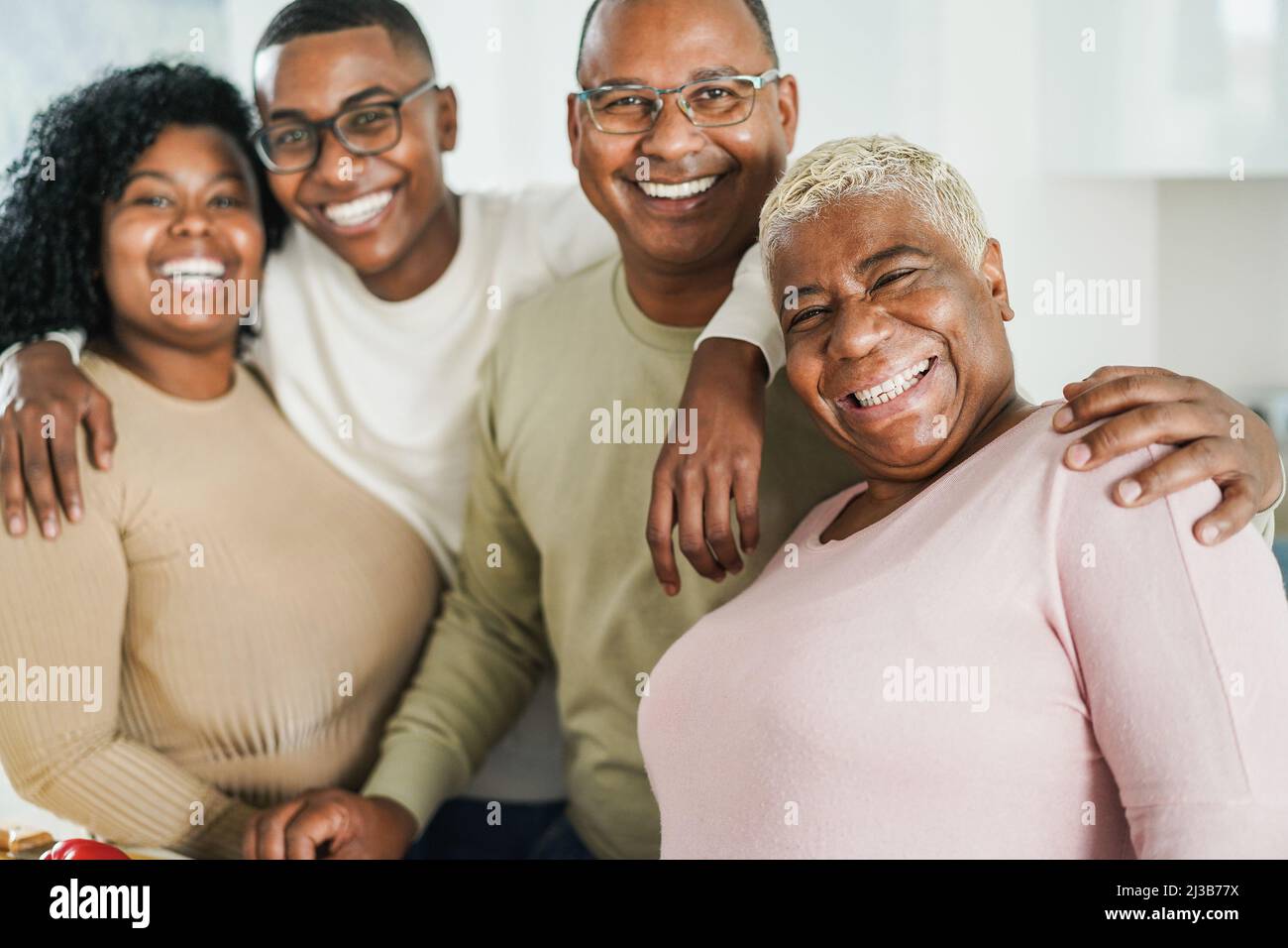 Happy black family having fun inside kitchen at home - Focus on mother ...