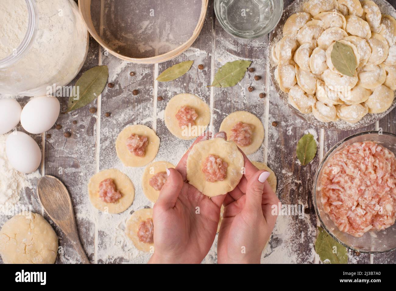 process of cooking pelmeni with chef's hands, top view Stock Photo - Alamy