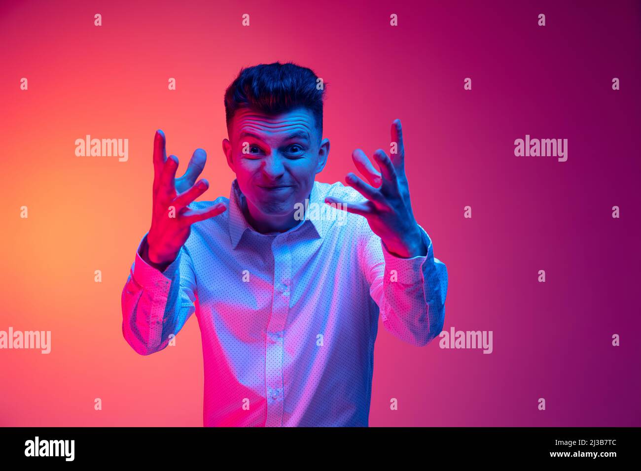 Emotional young stylish man, student looking angry at camera isolated ...