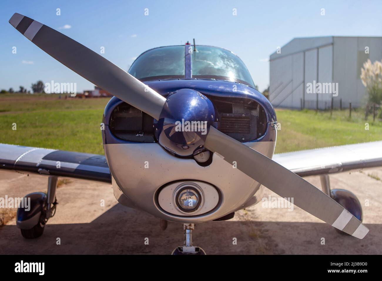 Frontal close-up view of engine and propeller of single-engined light ...