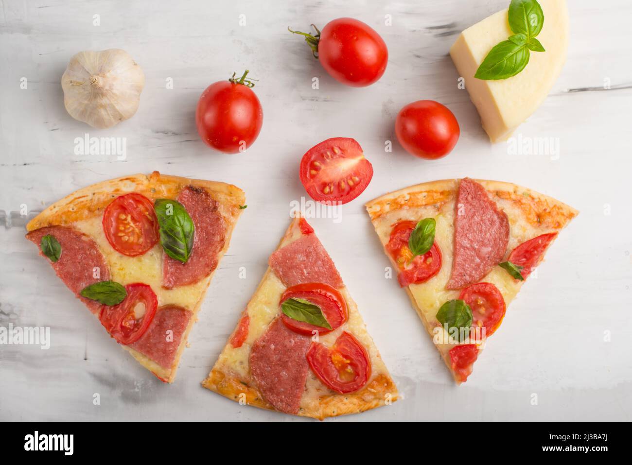 Delicious sliced pizza with tomatoes, mozzarella cheese, basil, and a ...