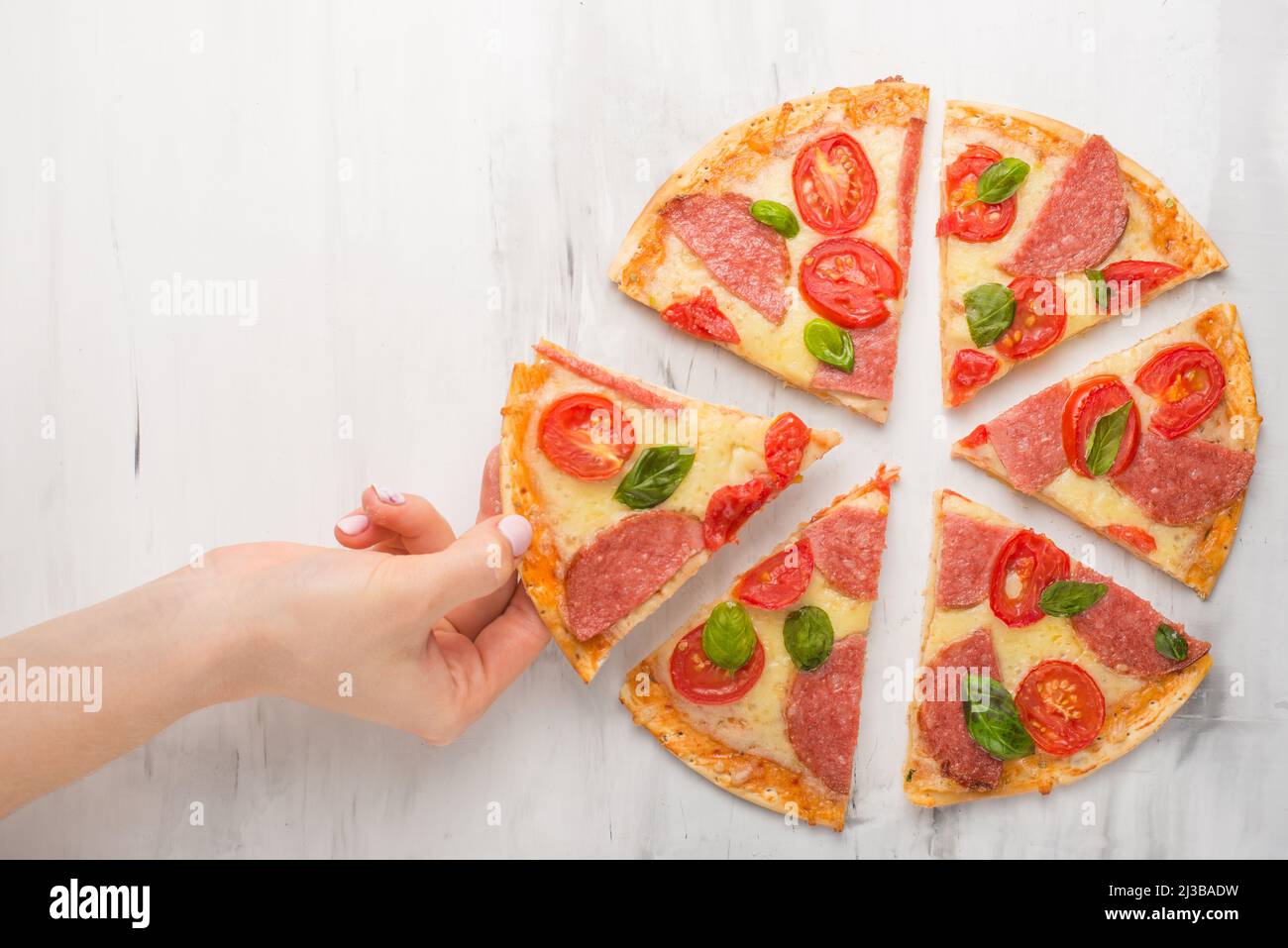 Hands taking pizza slices hi-res stock photography and images - Alamy
