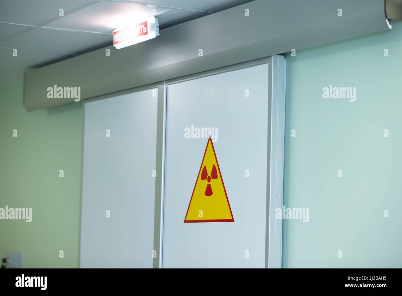 Radiation sign on the doors in the hospital. High radiation warning ...