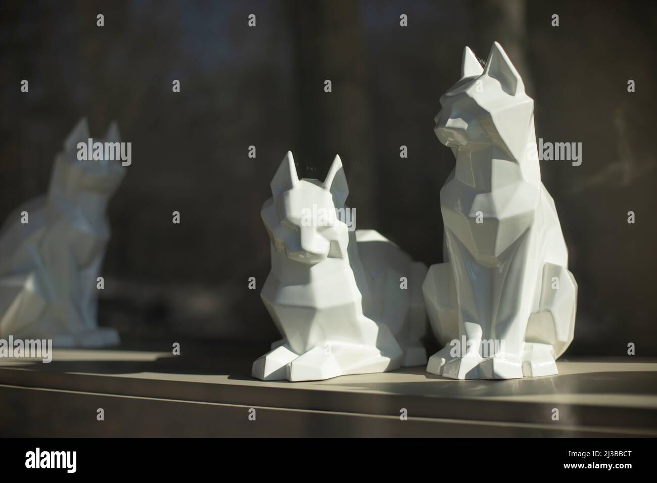Cubic figures of cats. Sculpture of white cat. Interior item. Light ...