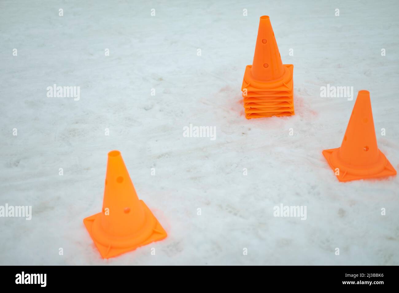 Orange caps in snow. Motion limiters. Signal triangles. Warning signs ...