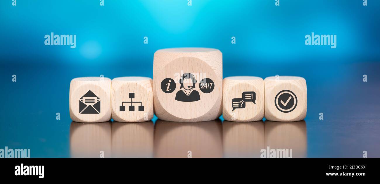 Wooden blocks with symbol of customer service concept on blue ...