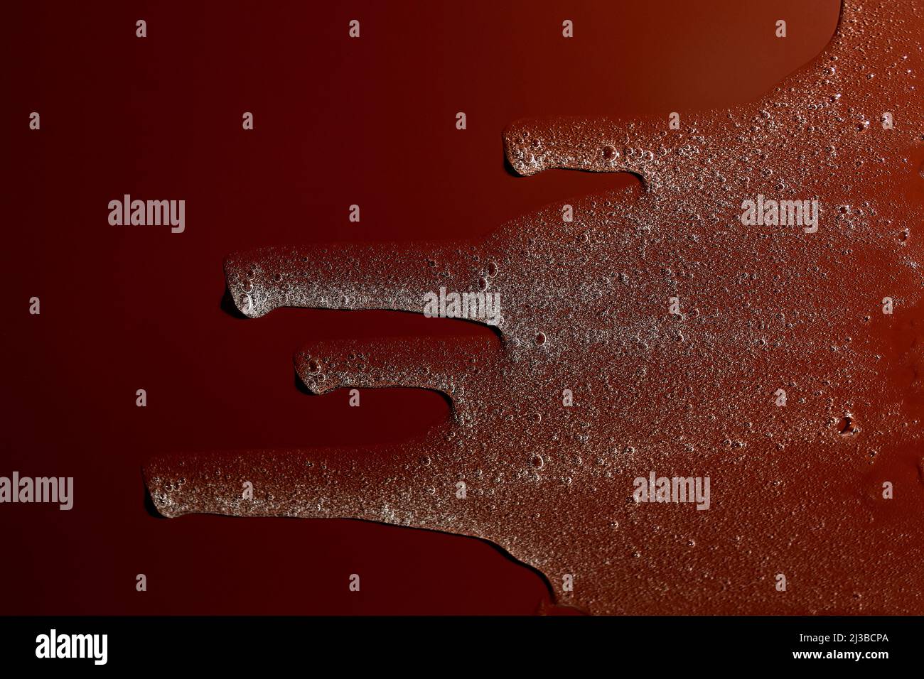 Cream liquid gel serum flows down on brown texture, makeup and ...