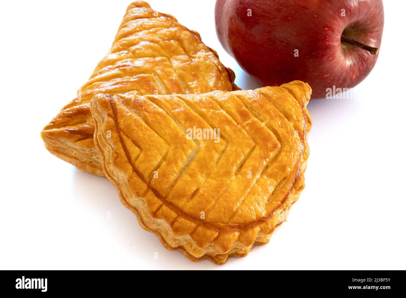apple turnovers and an apple isolated on white background Stock Photo ...