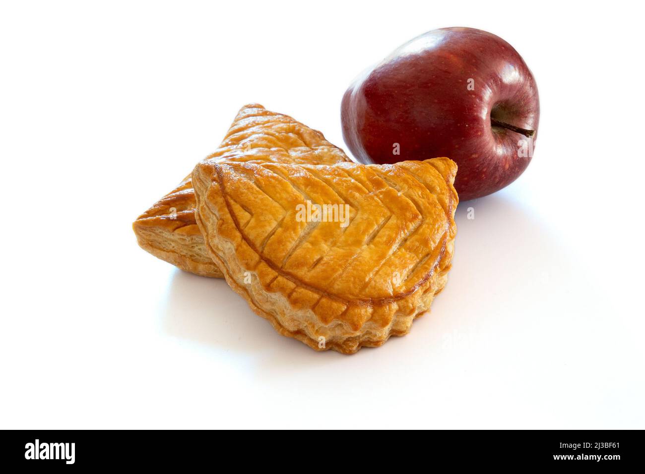 apple turnovers and an apple isolated on white background Stock Photo ...
