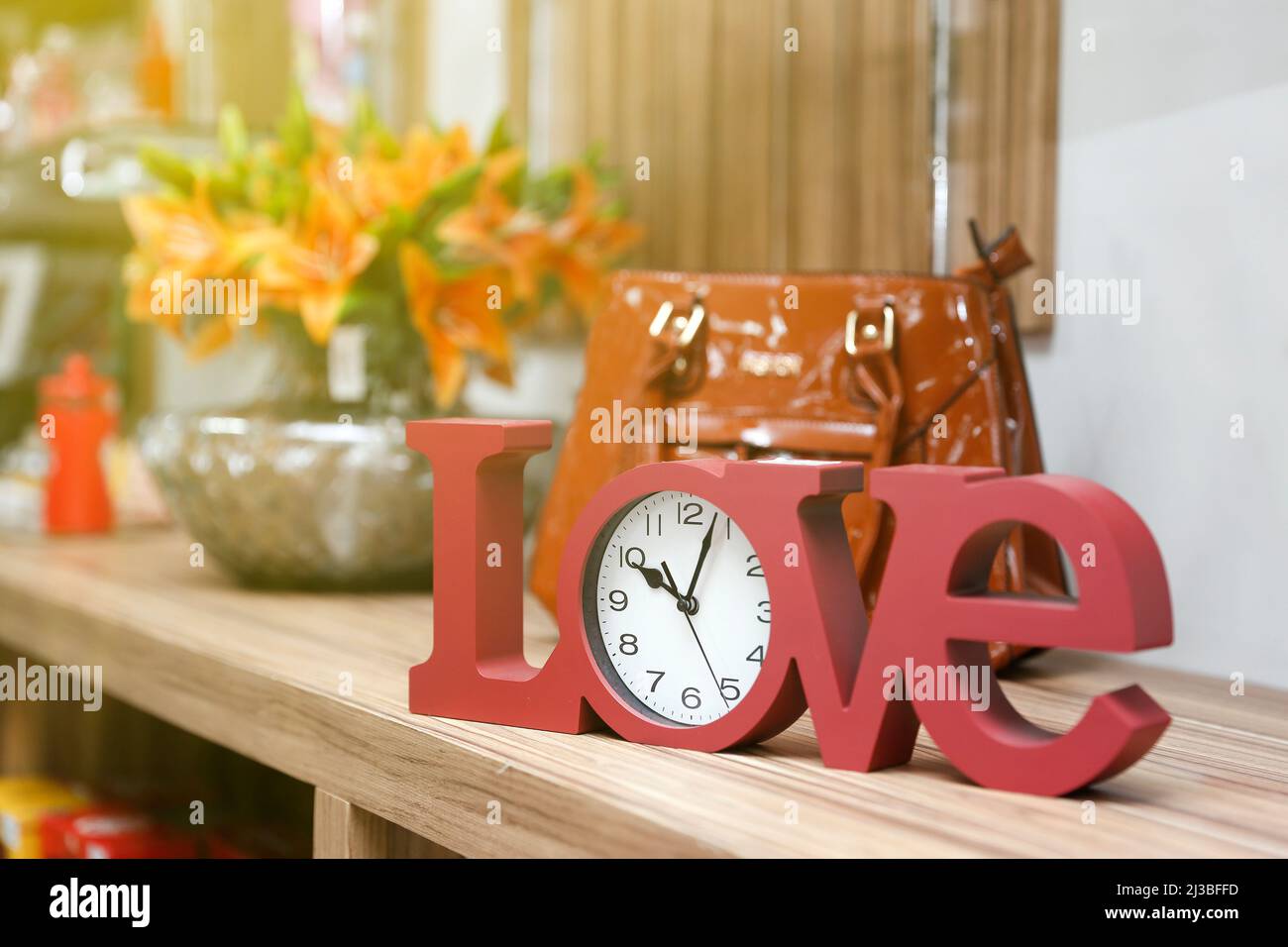 love wooden letters on clock in red color Stock Photo - Alamy