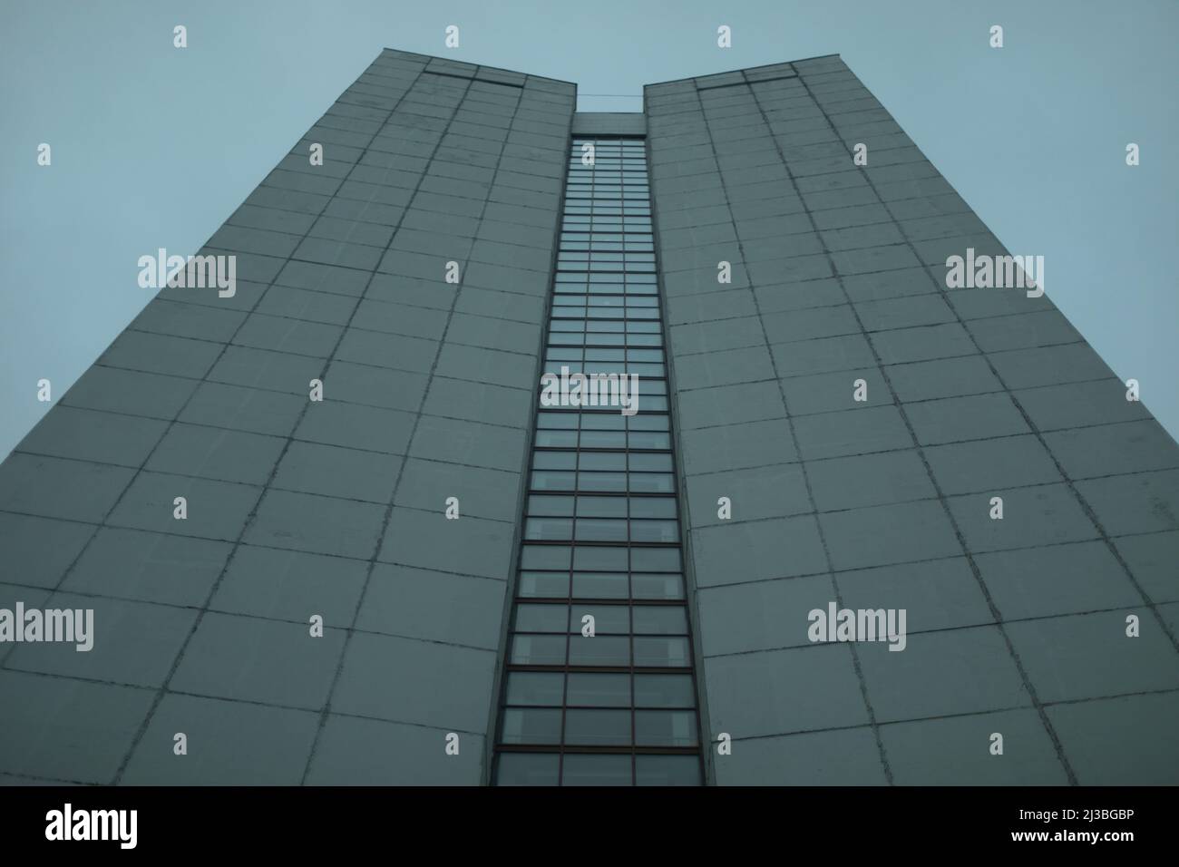 High-rise building on gray day. Architecture details. Surface of wall ...