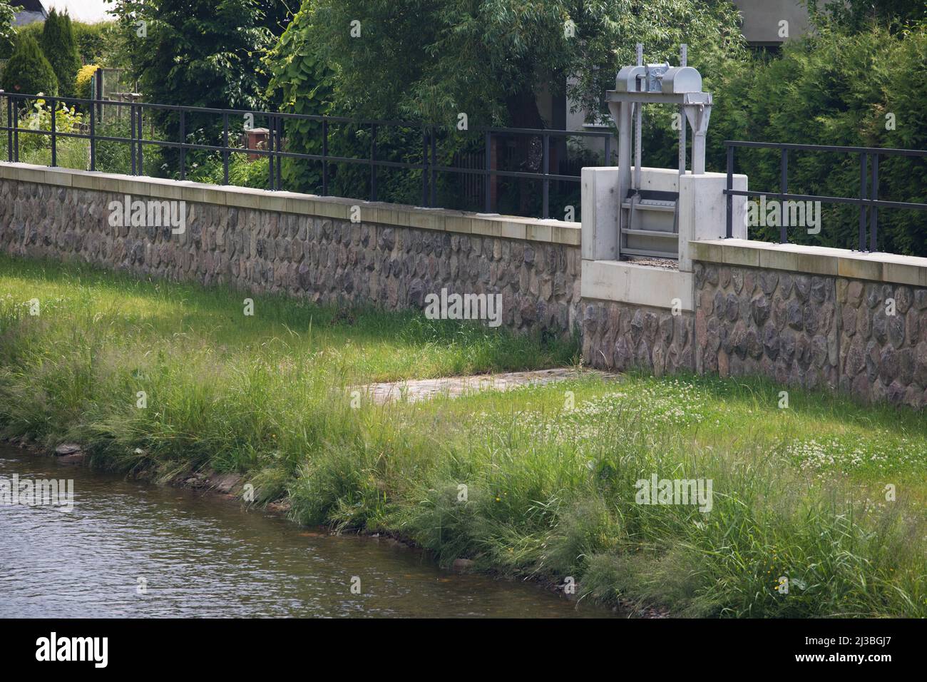 Modern flood protection wall in the style of the historic city wall ...