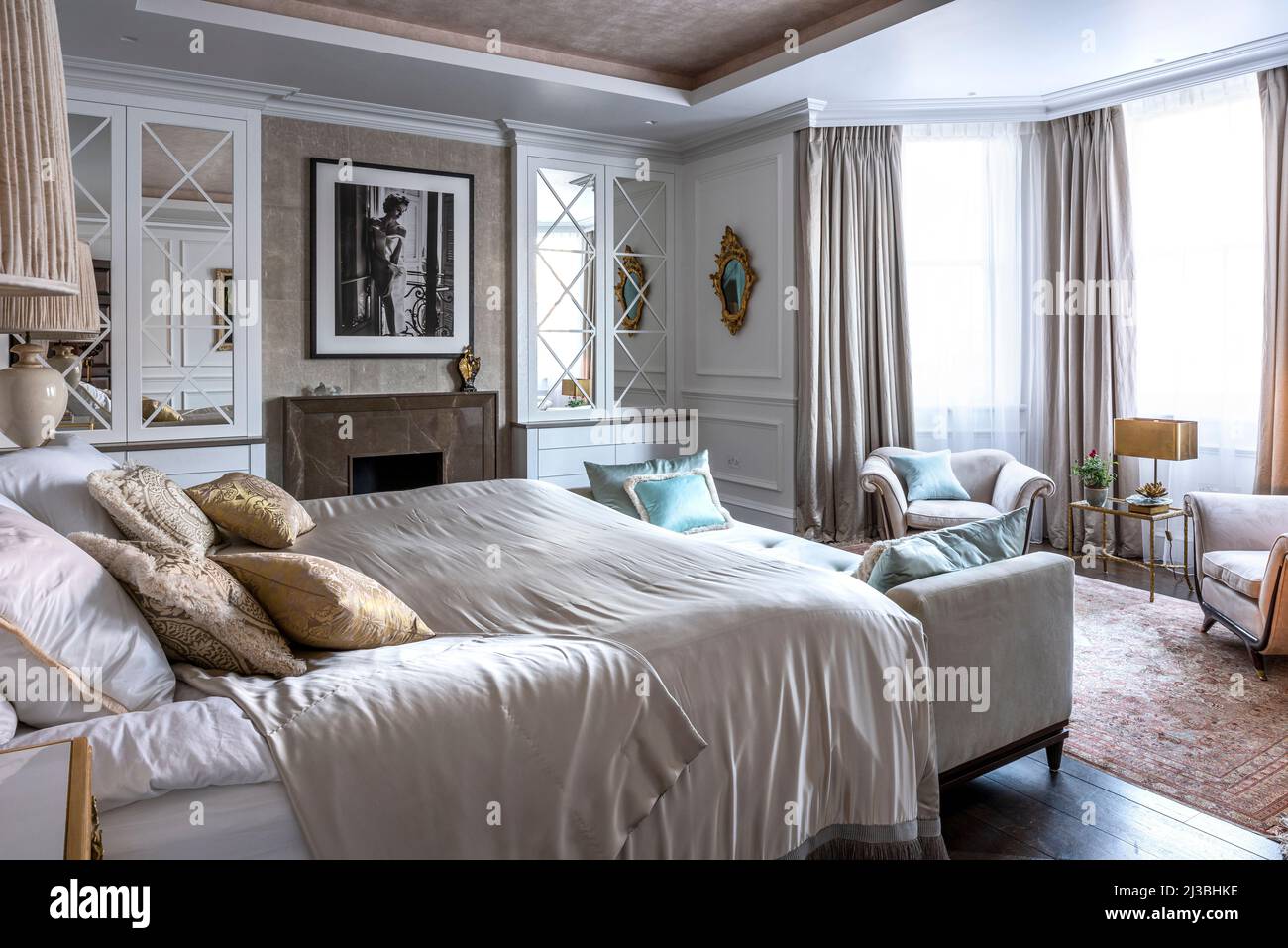 Savoir bed with daybed and 1940s armchairs and bronze table lamp in ...