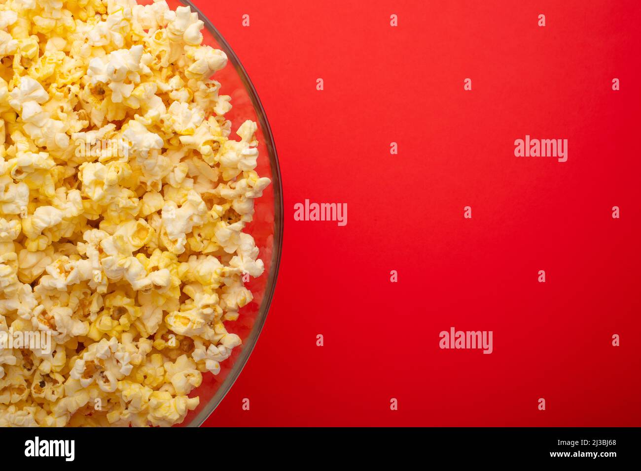 plate with popcorn on a red background. layout. top view. concept of ...
