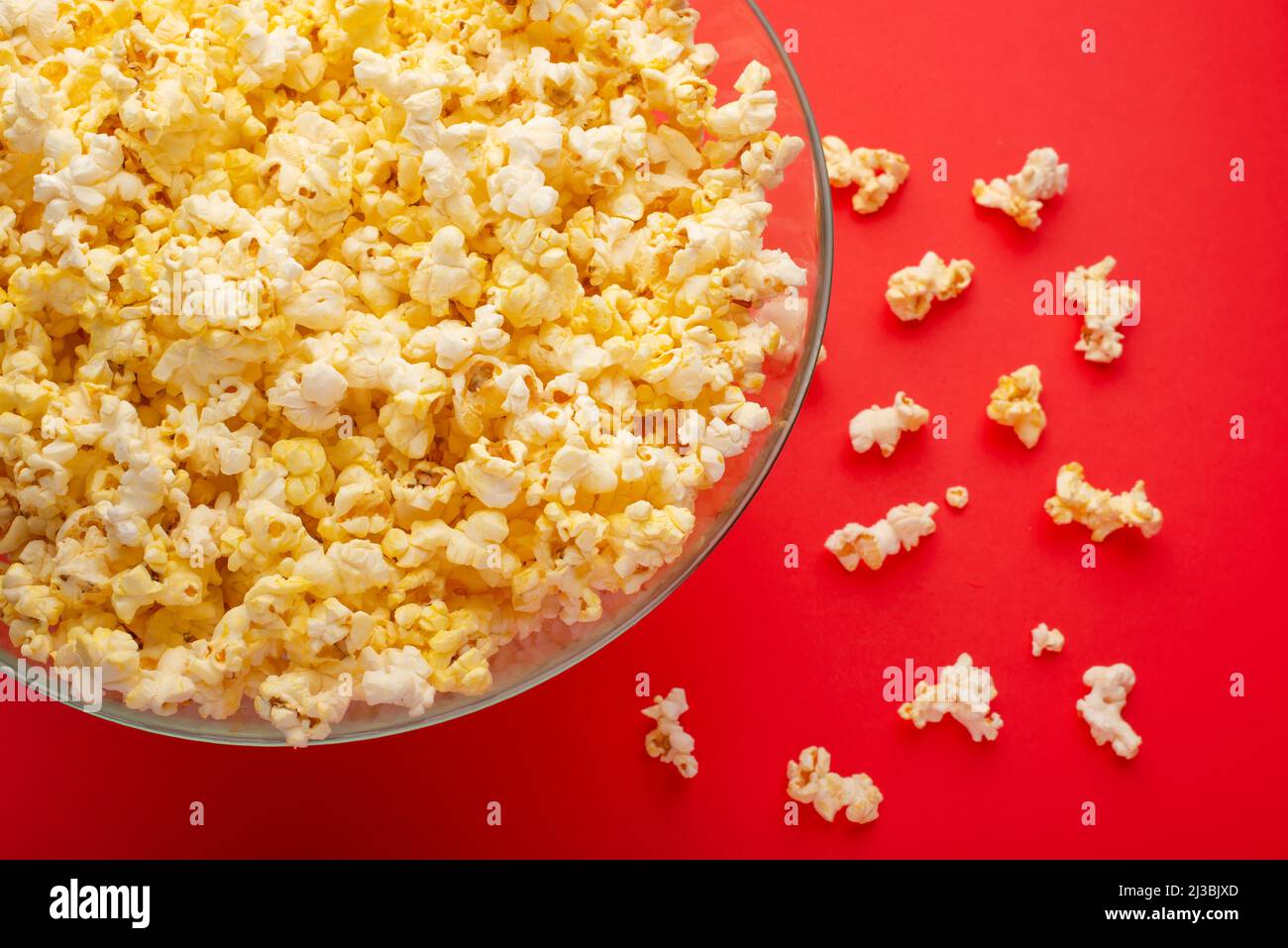plate with popcorn on a red background. layout. top view. concept of ...
