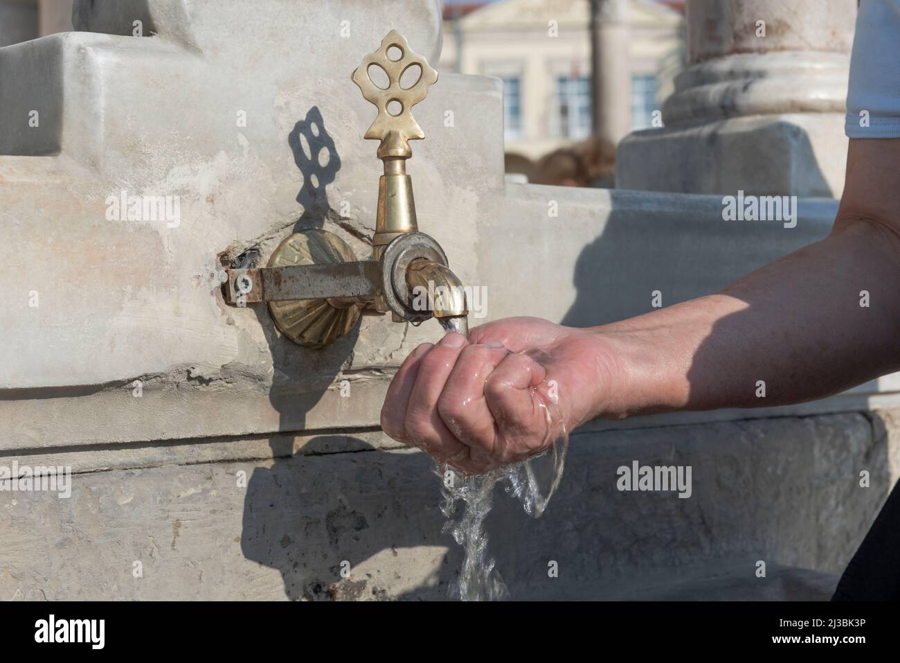 Hand washing in old fountain hi-res stock photography and images - Alamy
