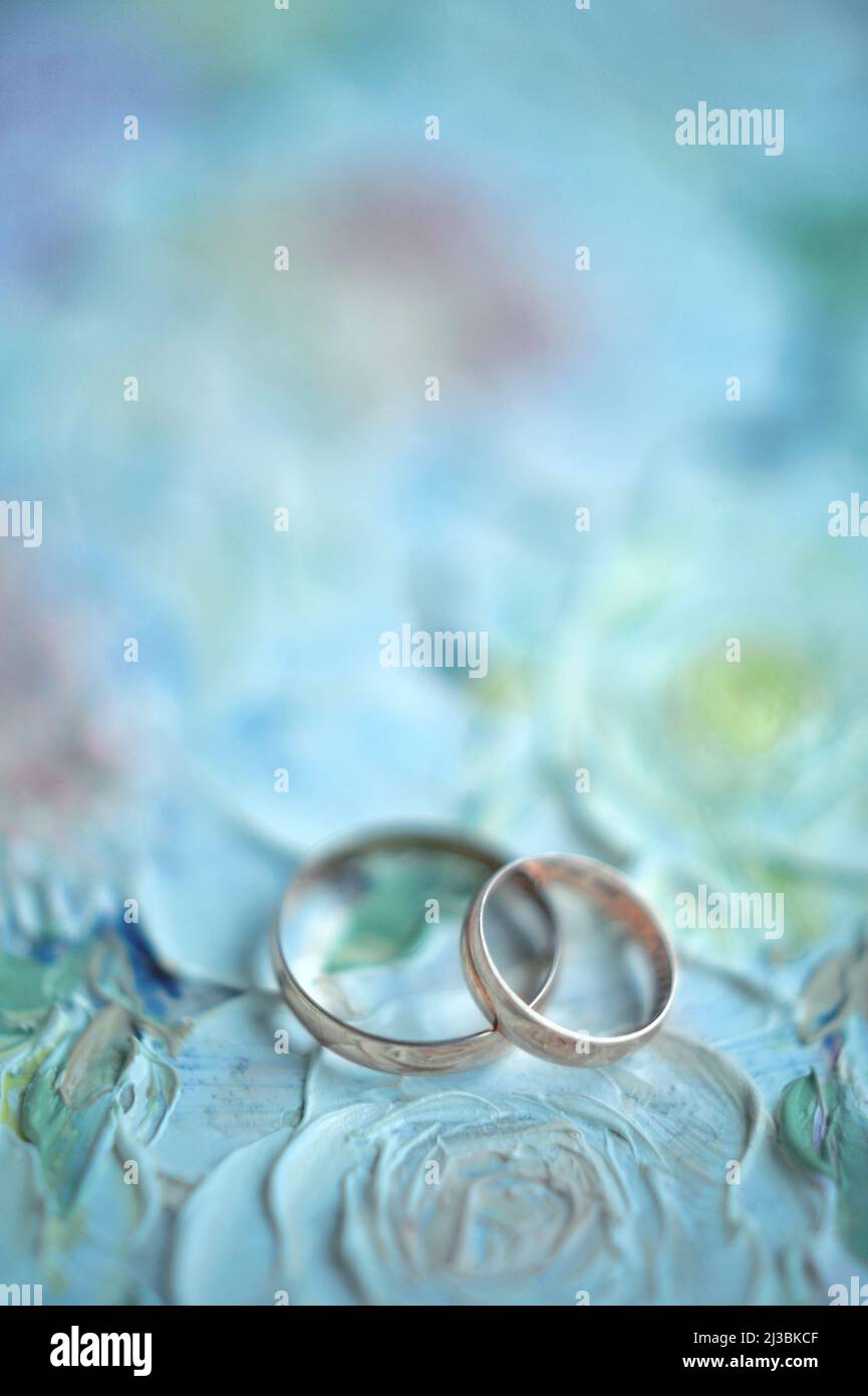 Classic wedding rings on blue background with place for inscription ...
