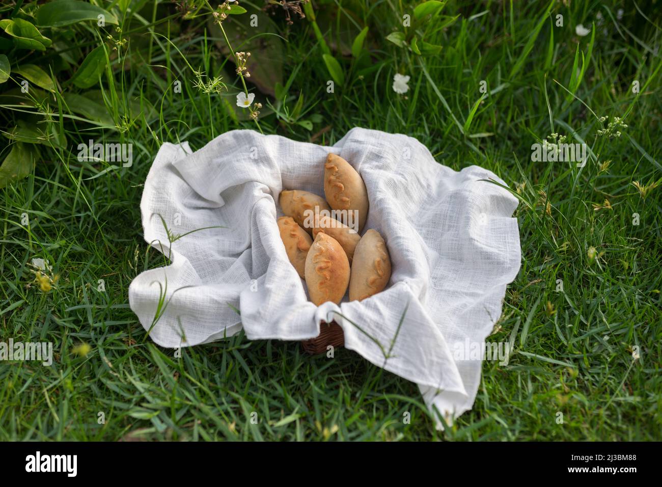 Composition of white flour buns in basket with white white cloth napkin ...