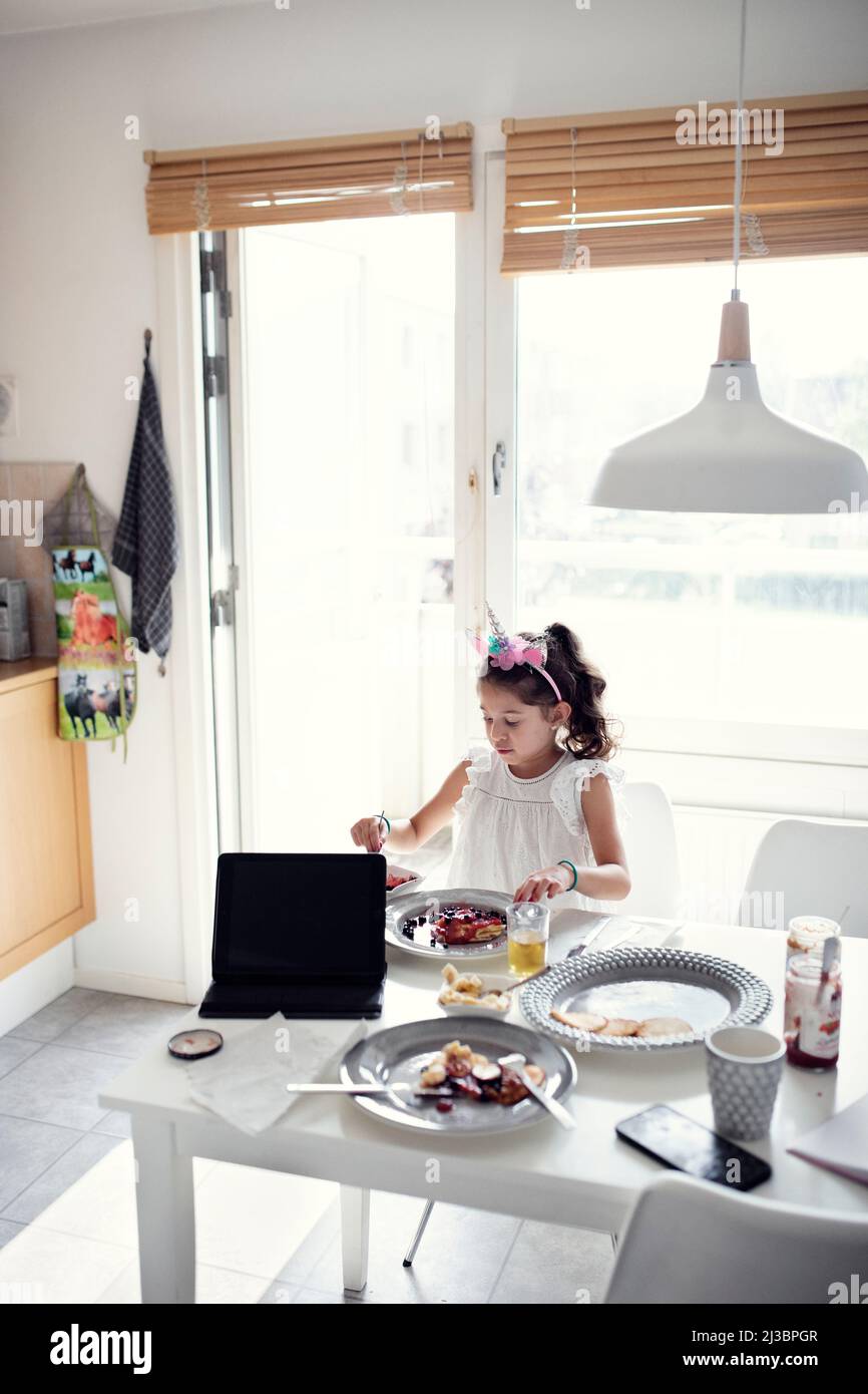 Girl at dining table Stock Photo - Alamy