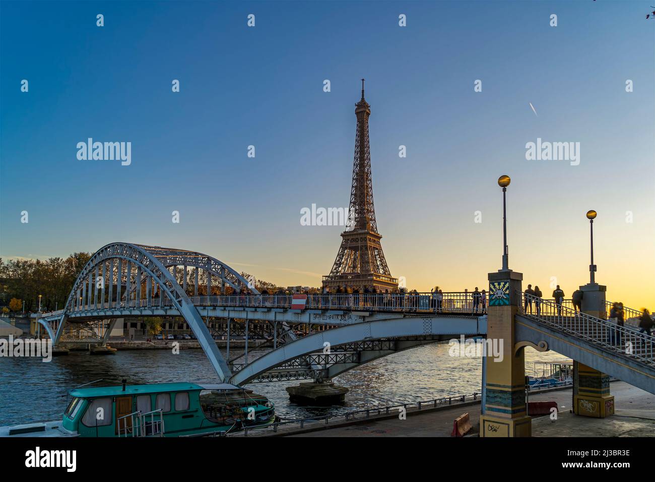 Eiffel Tower Overlooking a Pedestrian Bridge With Tourists Enjoying the ...