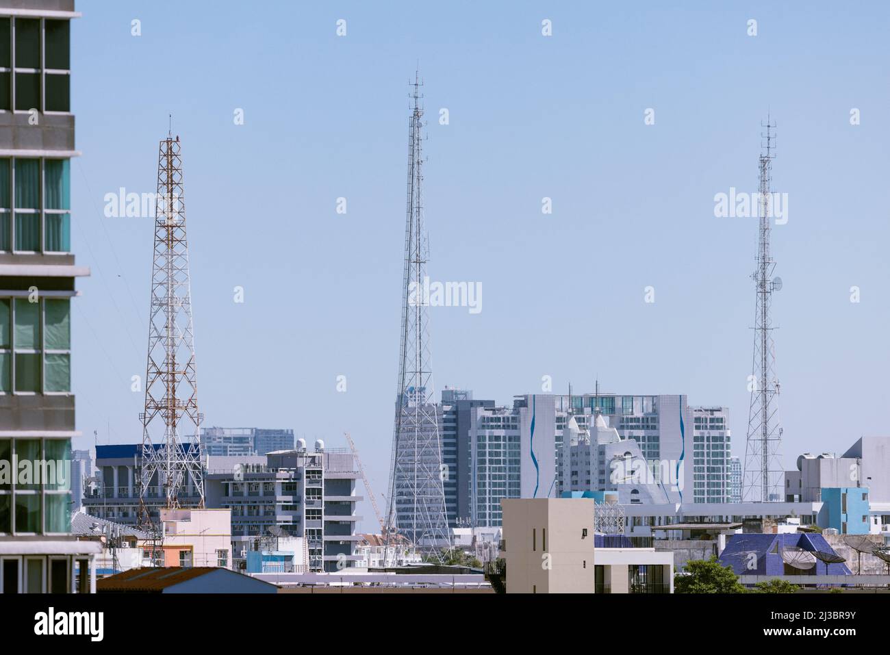 Communications towers and modern buildings in city center Stock Photo ...