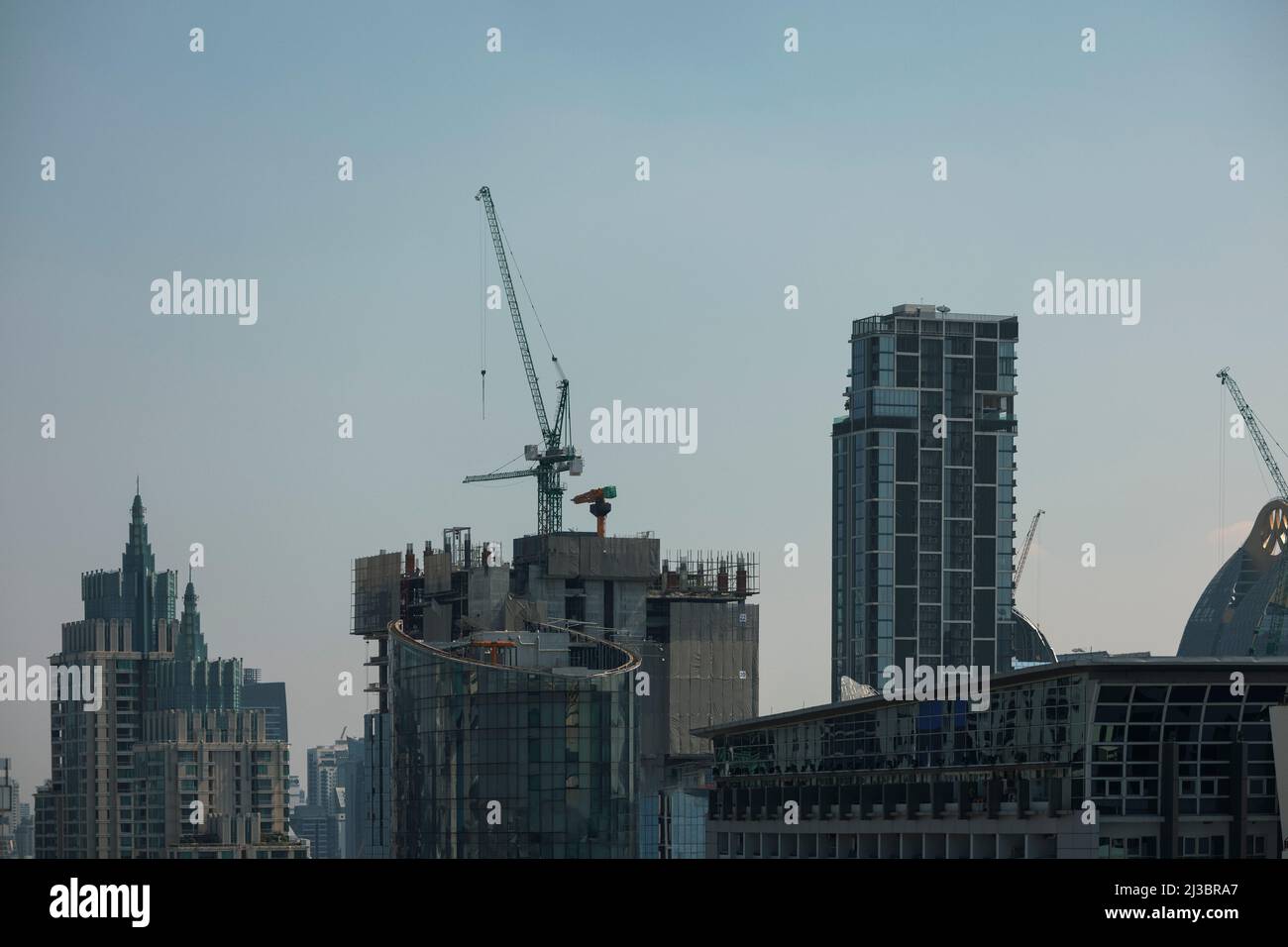 Cityscape with skyscrapers and construction cranes Stock Photo - Alamy
