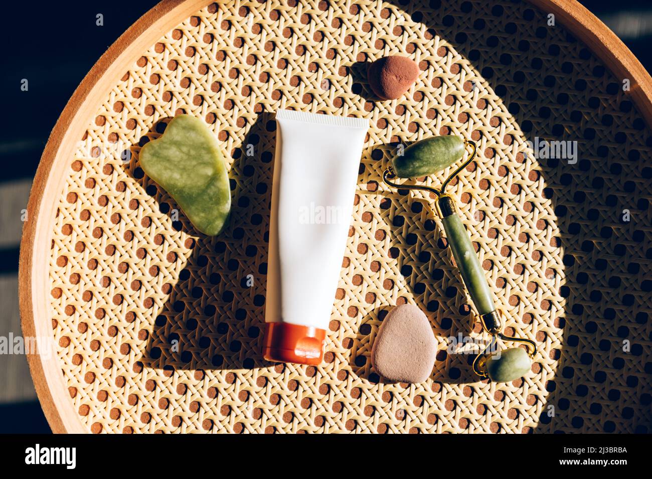 Jade face roller and Gua sha stone Stock Photo - Alamy