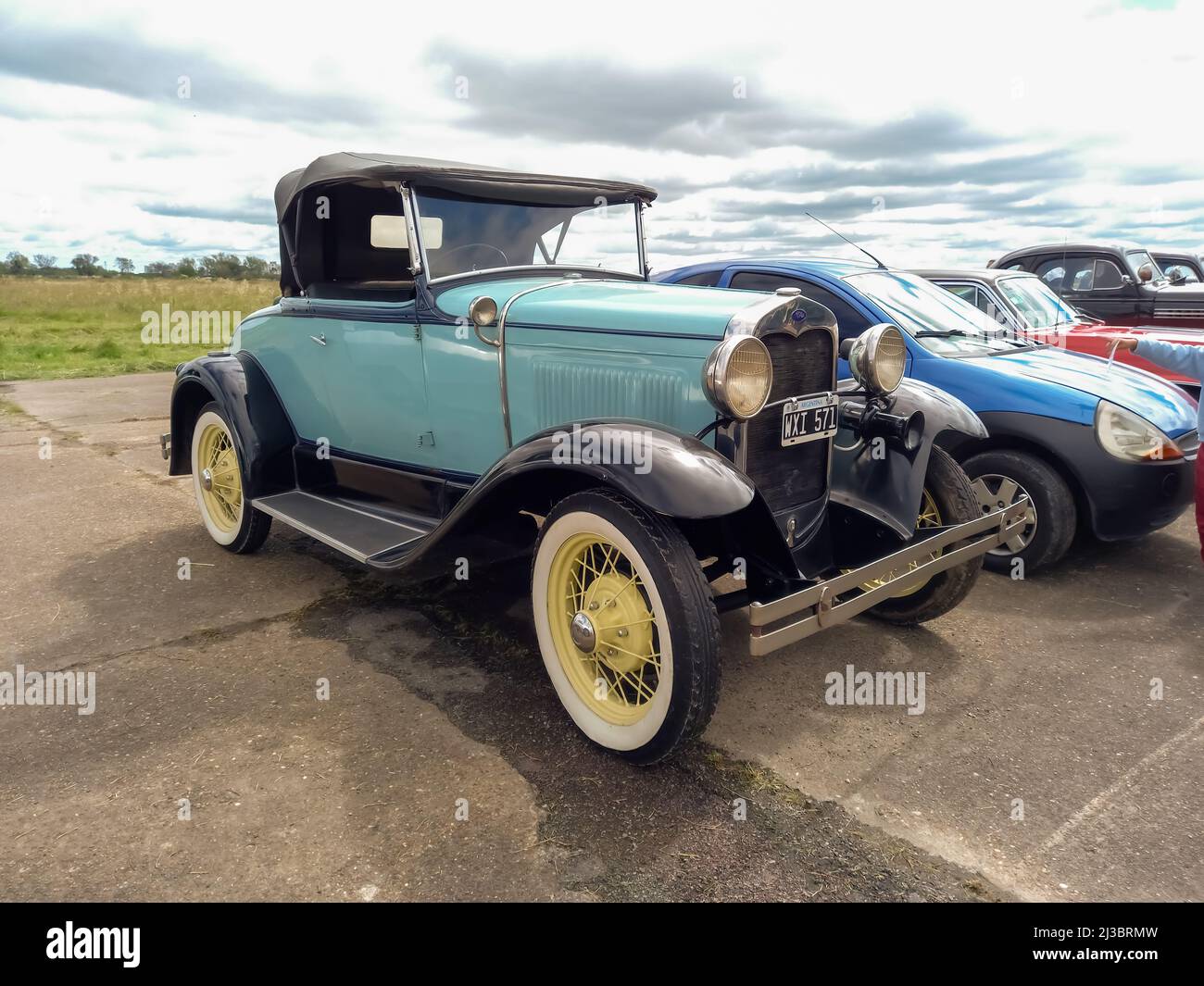 Old cyan Ford Model A coupe roadster circa 1930 parked at an airstrip ...