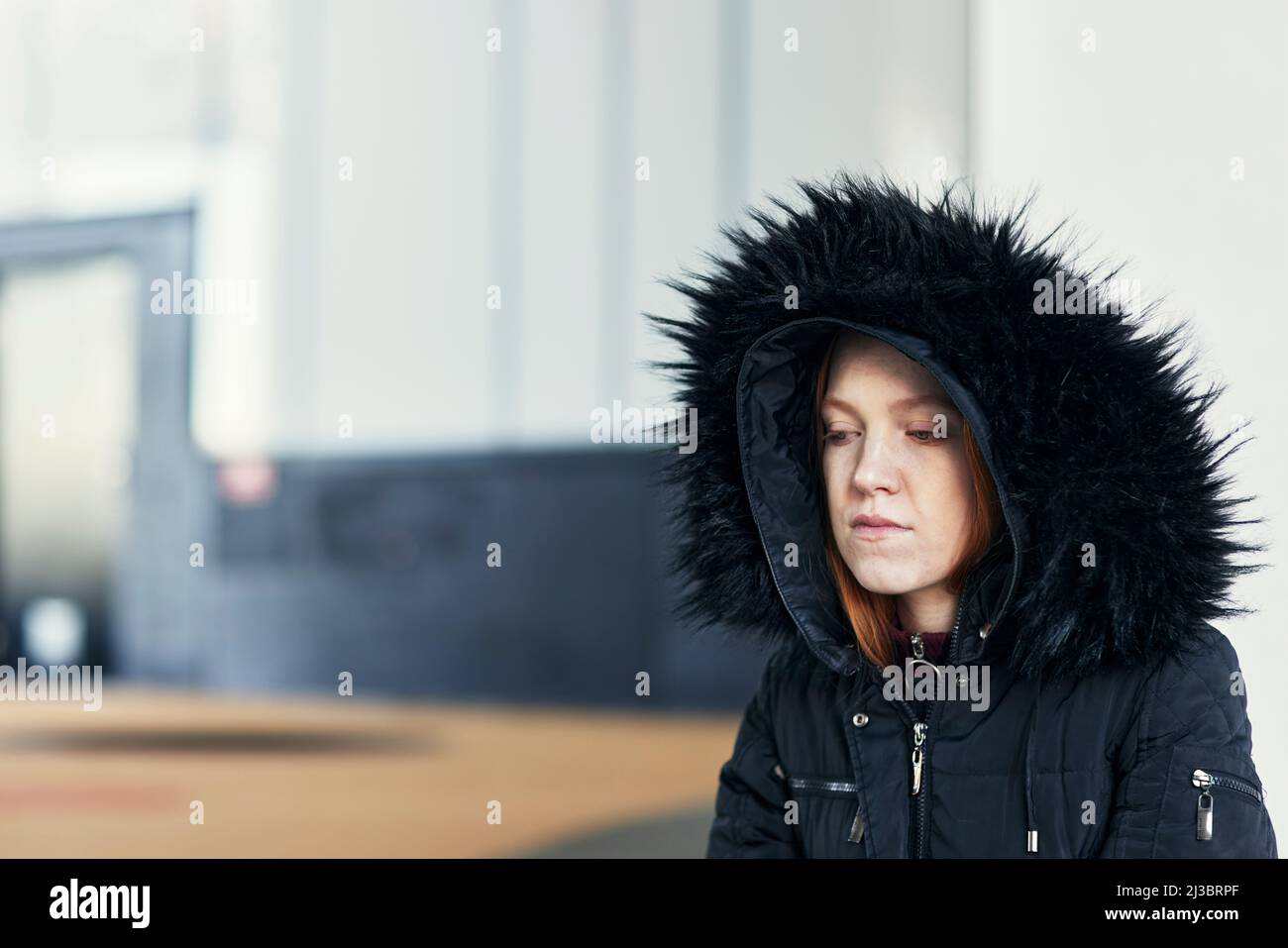 Young woman wearing hood Stock Photo - Alamy