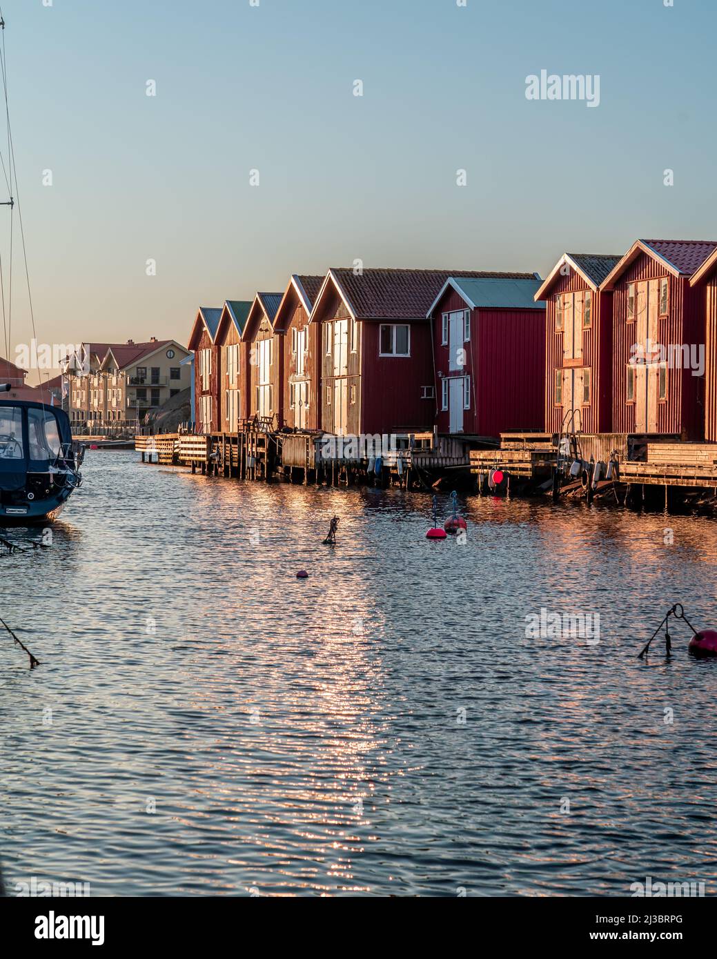 Portrait photo of a row of traditional red boathouses on the scenic ...