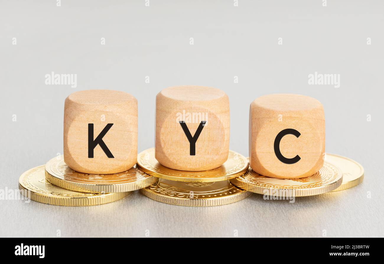 KYC or Know your customer concept. Coins and wooden blocks with text ...
