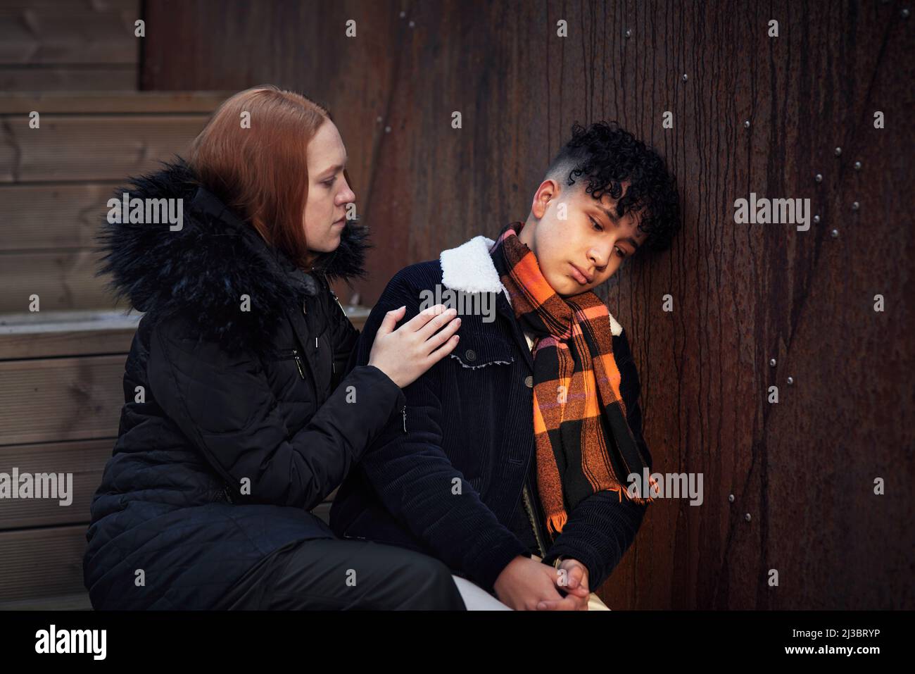 Young woman touching and comforting boy Stock Photo - Alamy