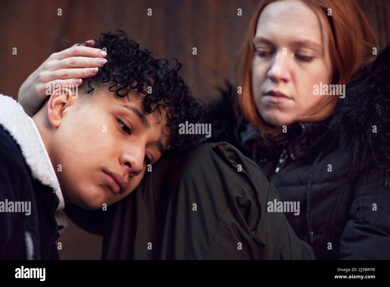Young woman touching and comforting boy Stock Photo - Alamy