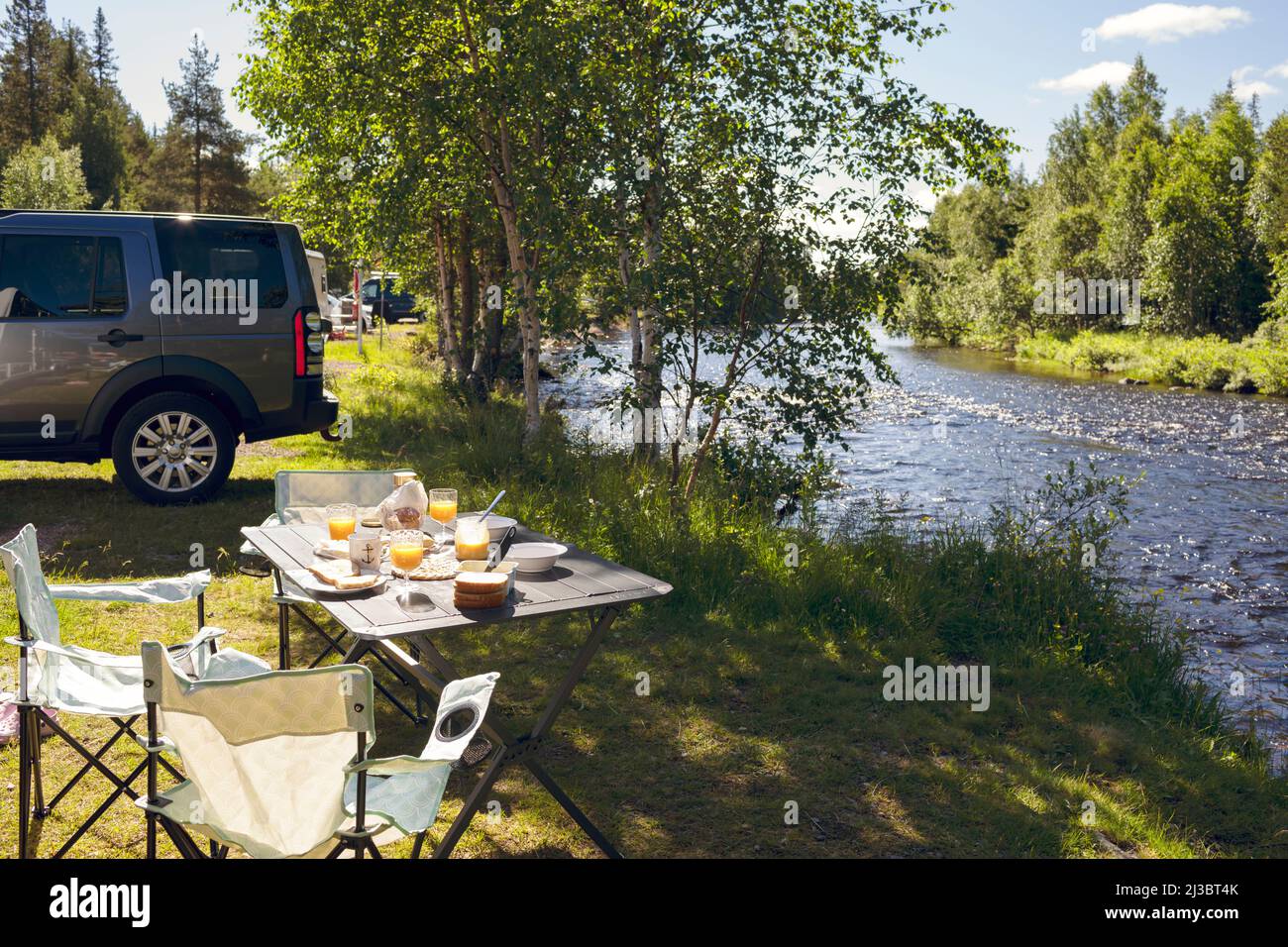 Food on table at river Stock Photo - Alamy
