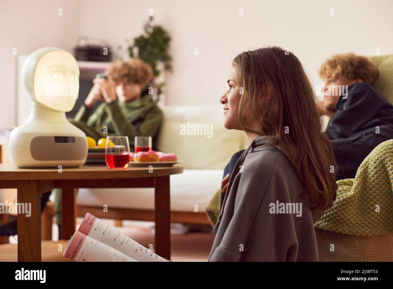 Girl doing homework with robotic voice assistant Stock Photo - Alamy