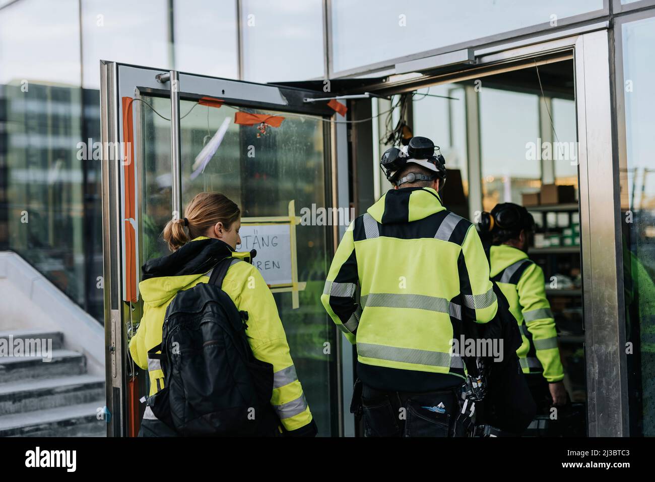 Workers entering construction site Stock Photo - Alamy
