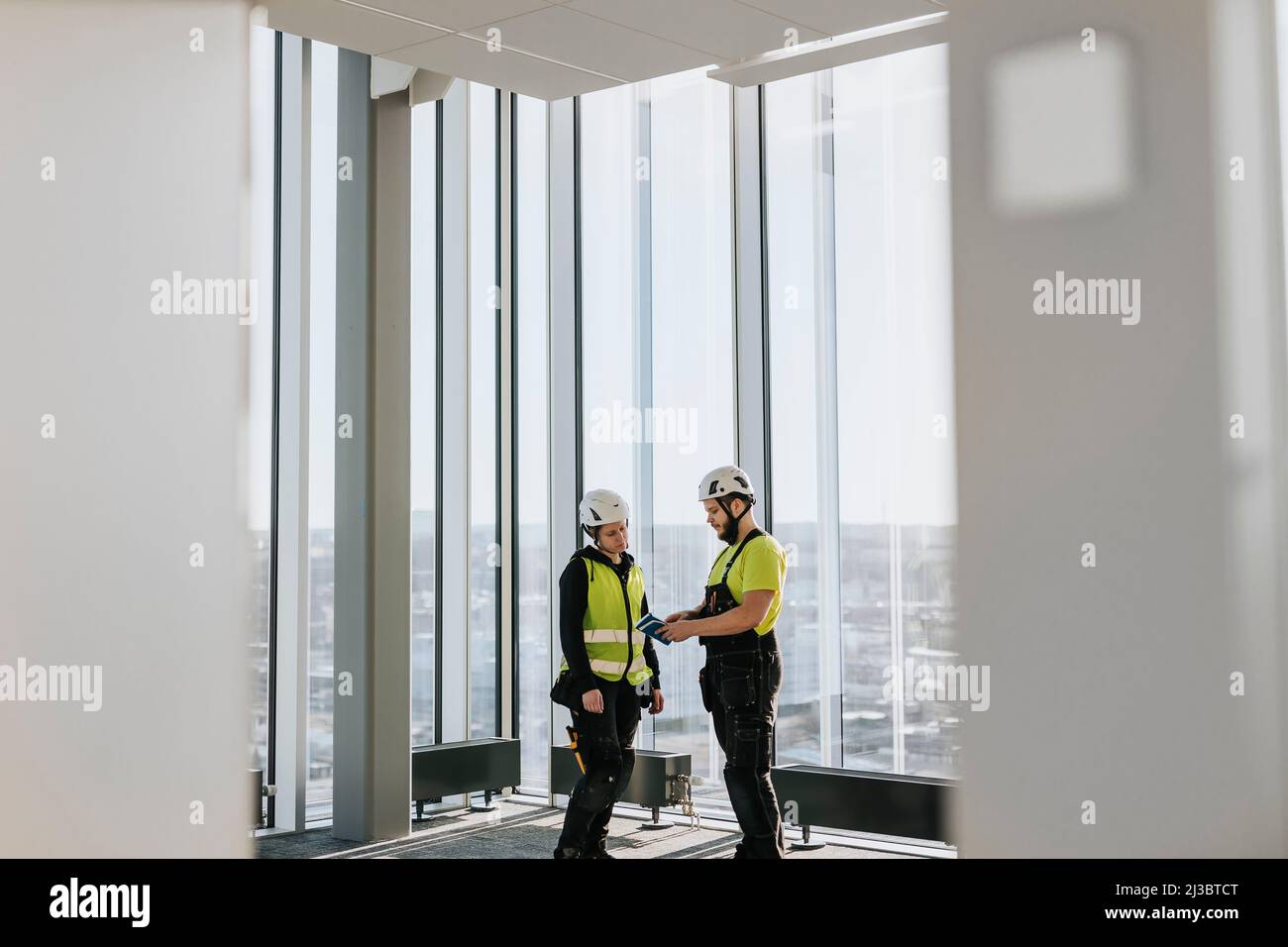 Workers talking at construction site Stock Photo - Alamy