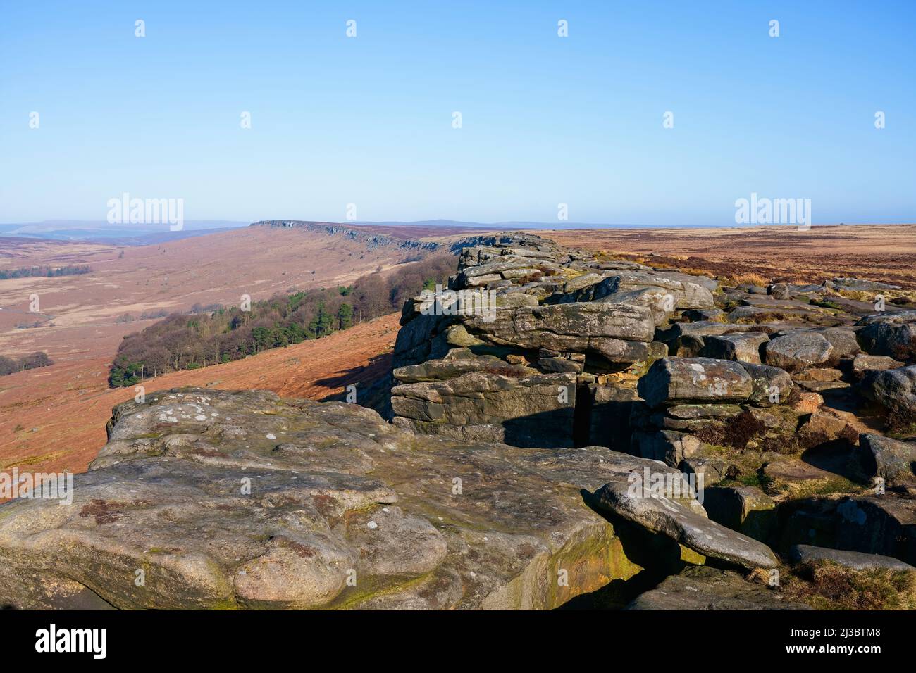 Weathered gritstone rocks along the top of Stanage Edge on a misty ...