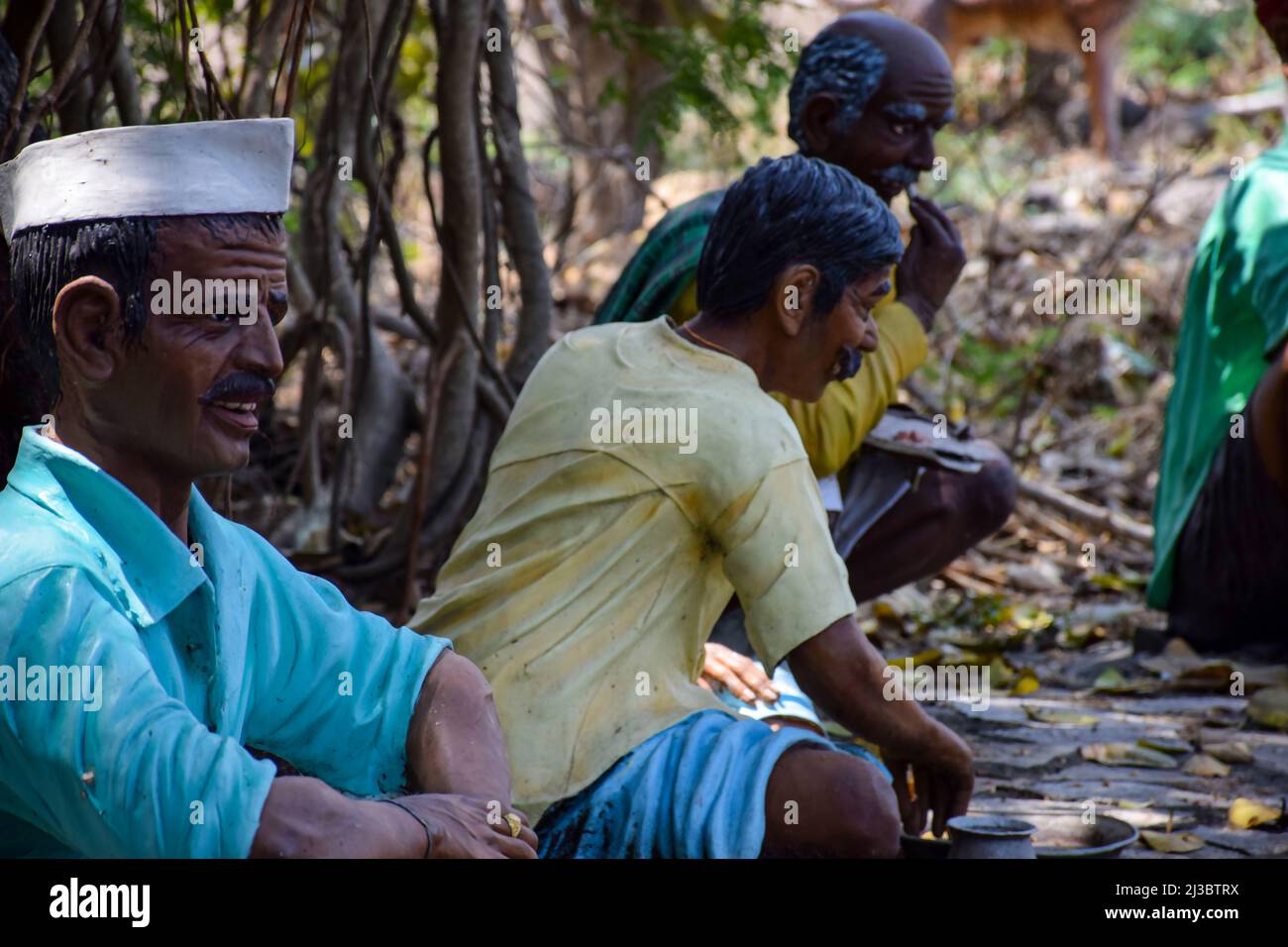 The statues of Indian villagers wearing traditional and simple cloths ...