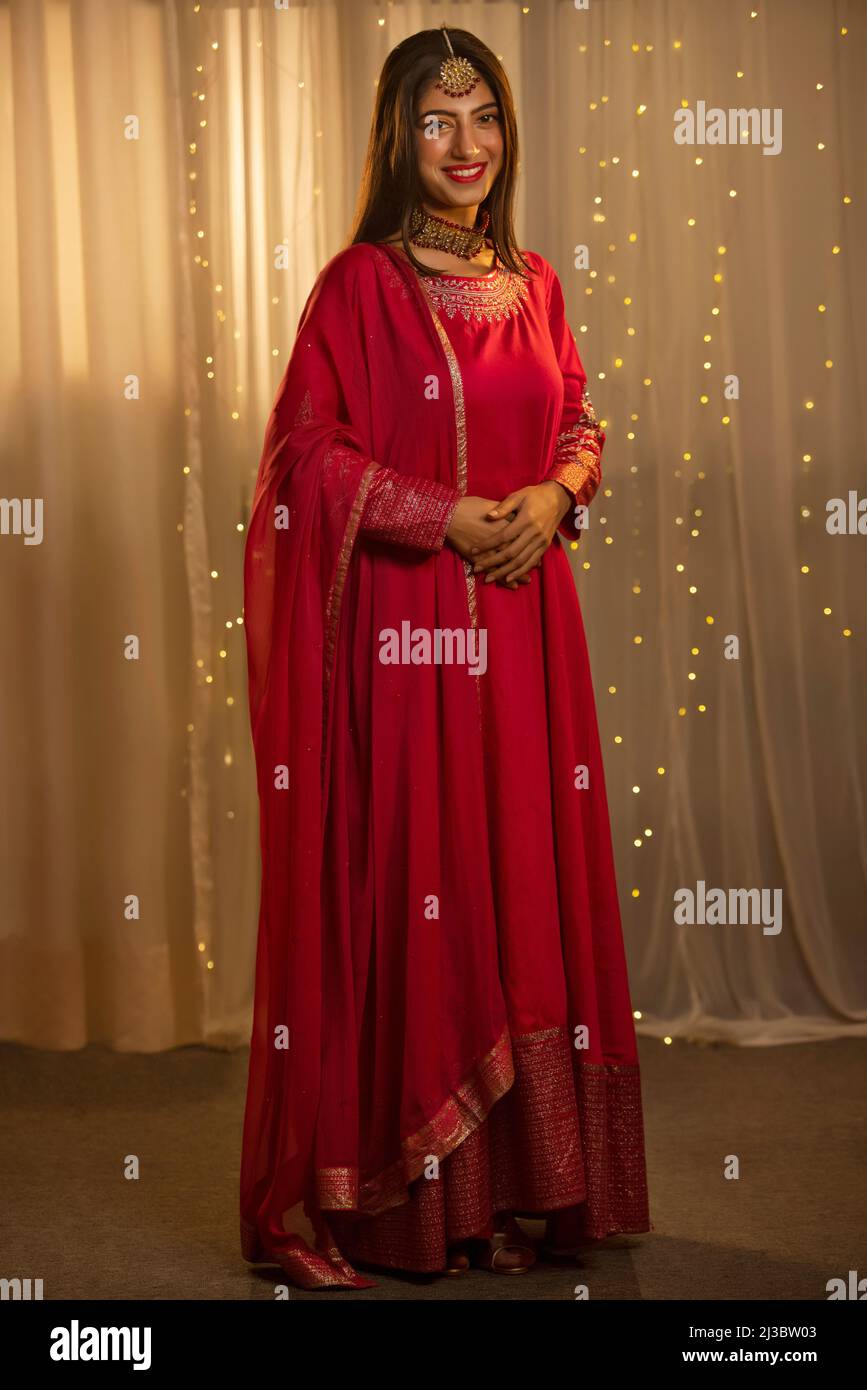 Portrait of an Indian girl in traditional outfit looking at camera with ...