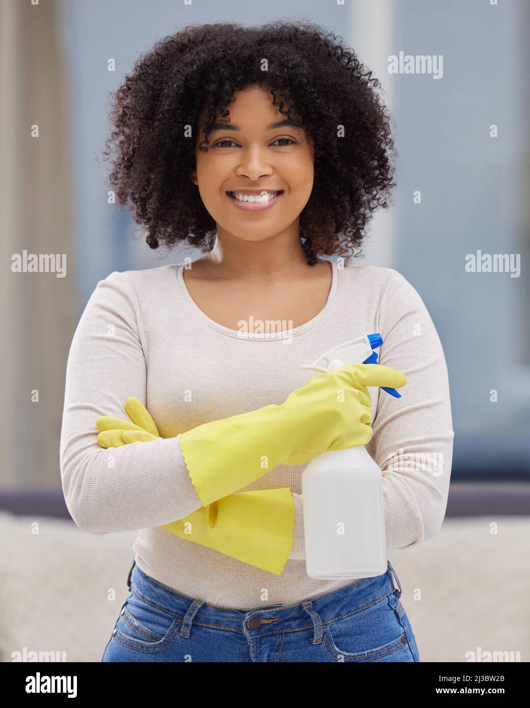 Time to get cleaning. Shot of an attractive young woman standing alone ...