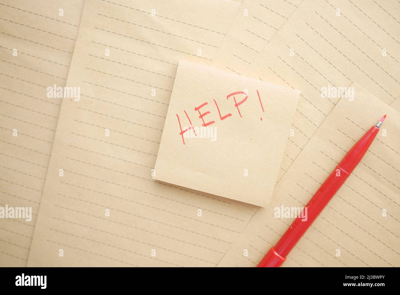 the test help on a paper with a red color pen on table Stock Photo - Alamy