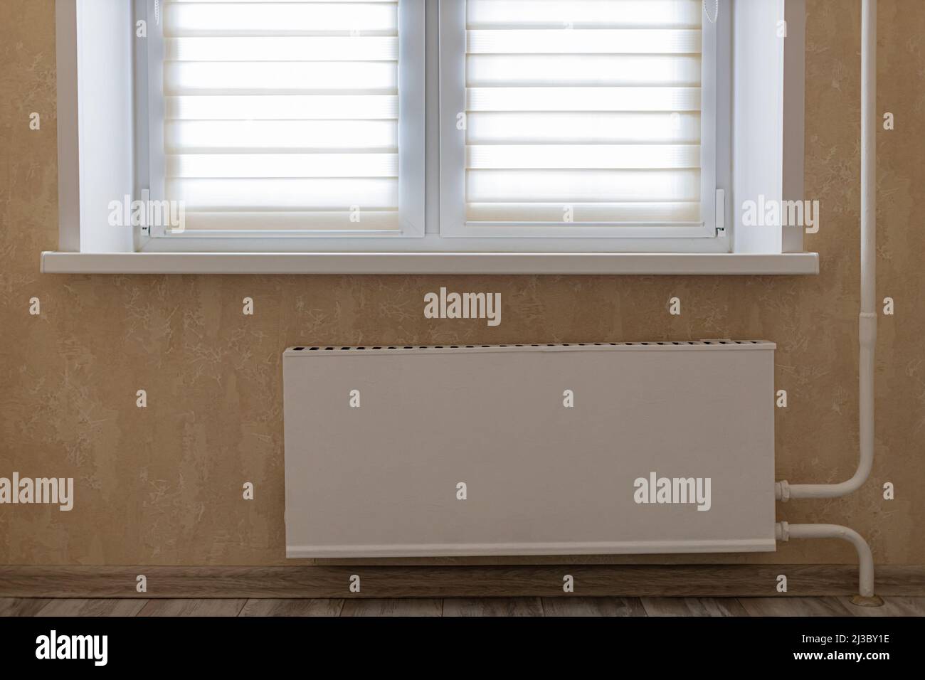 central heating radiator located under the window on the wall Stock ...