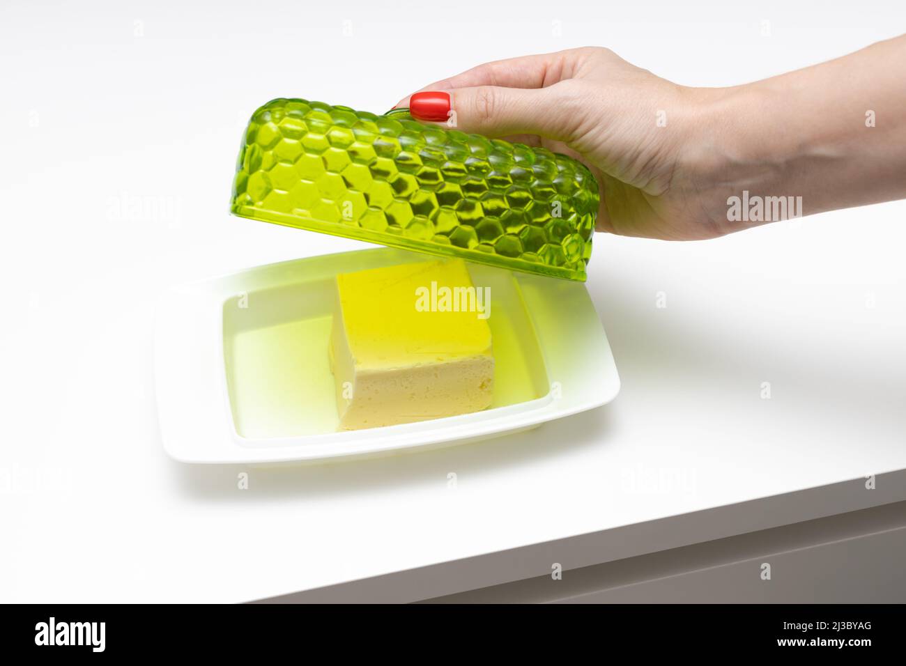 a woman's hand opens the lid of an oiler in which oil lies Stock Photo ...