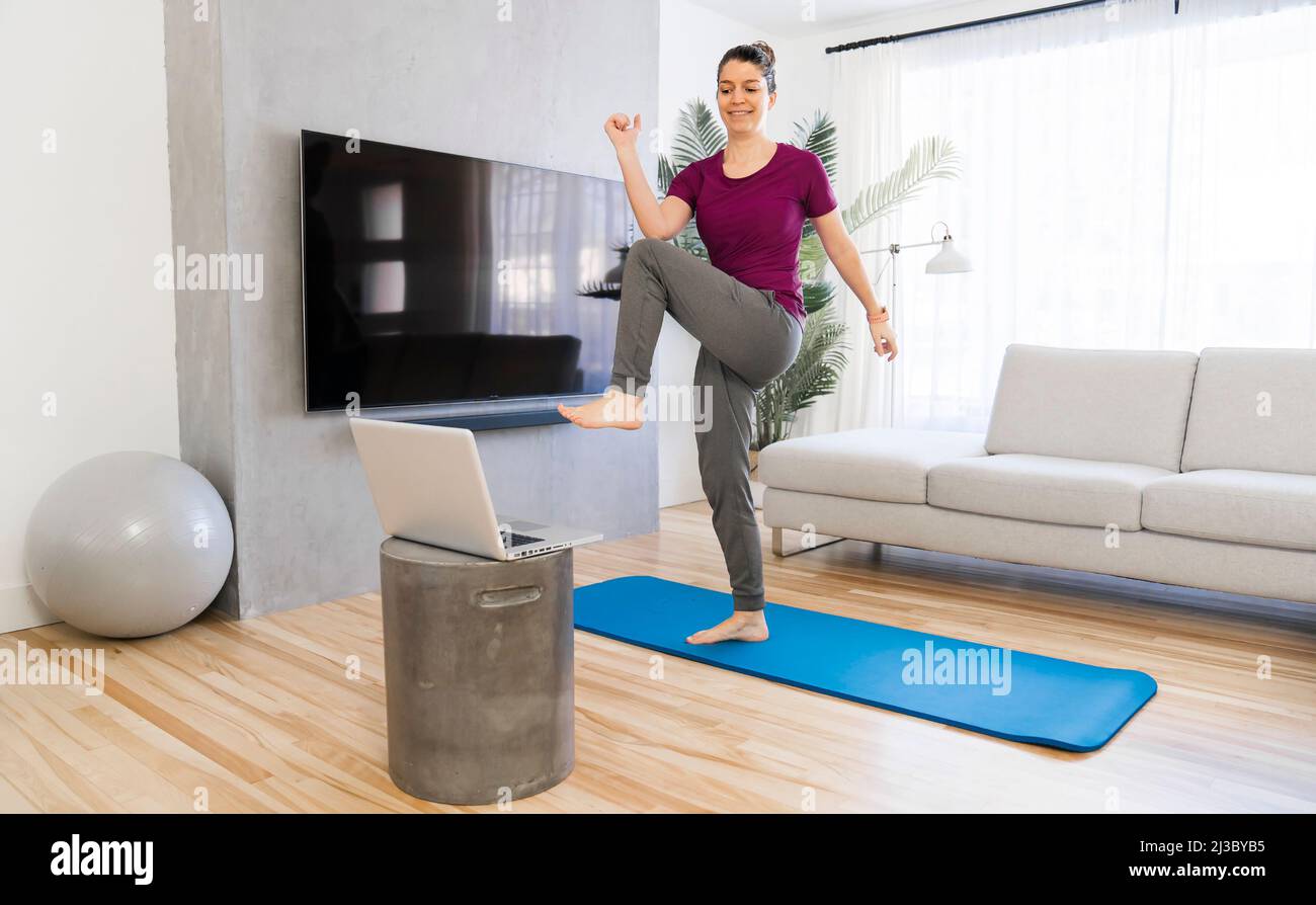 Attractive Fit woman Exercise at home on the living room Stock Photo ...